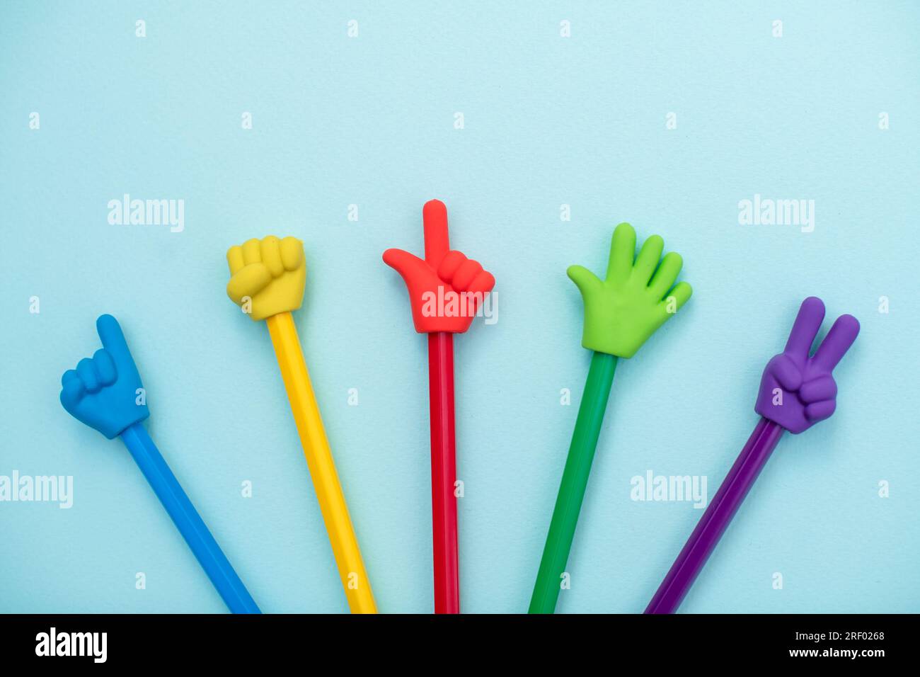 Colorful school erasers in the form of various gestures on colored ...