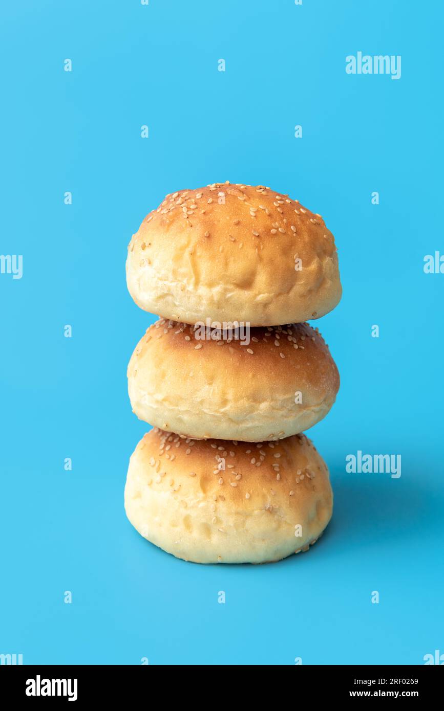 Close-up with homemade burger buns minimalist on a blue table. Freshly ...