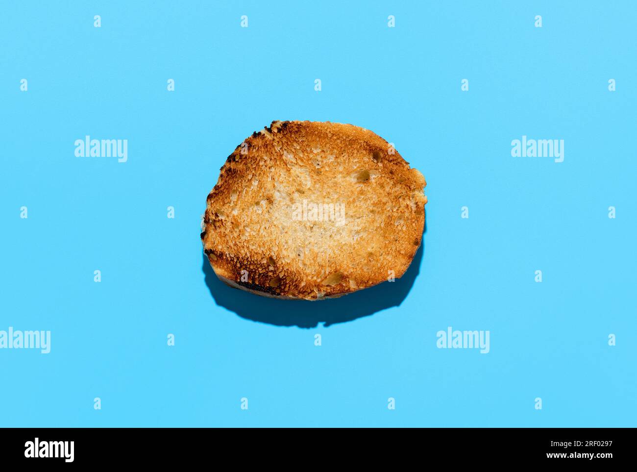 Above view with one toasted slice of baguette bread, minimalist on a ...