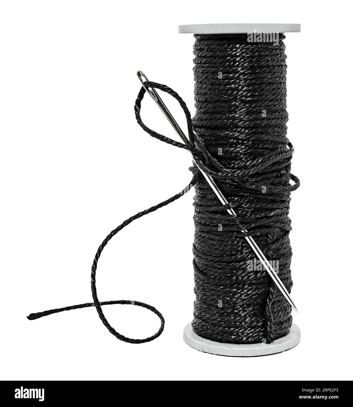 Plastic spool with black synthetic threads close-up. Needle and thread ...