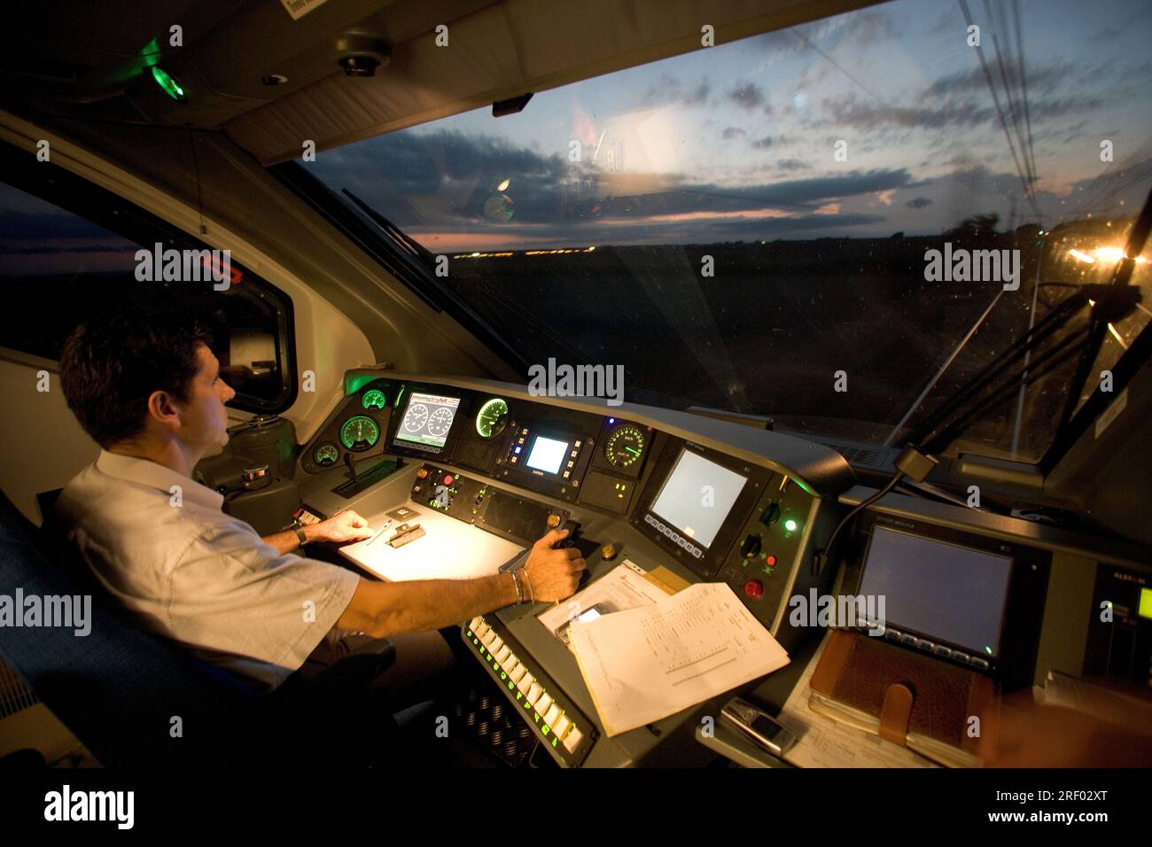 A train driver at the controls of a high speed inter-city train ...