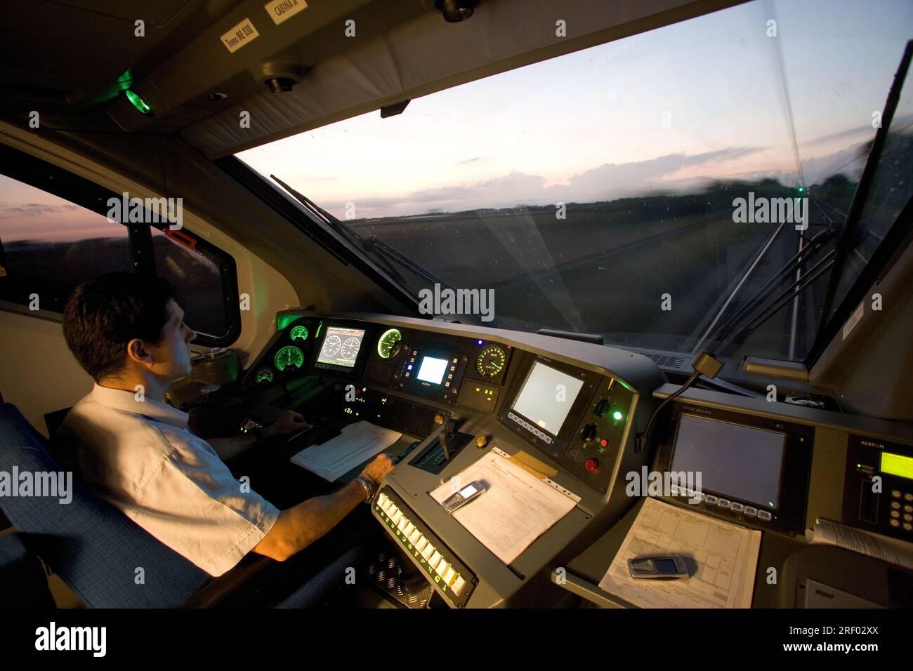 A train driver at the controls of a high speed inter-city train ...
