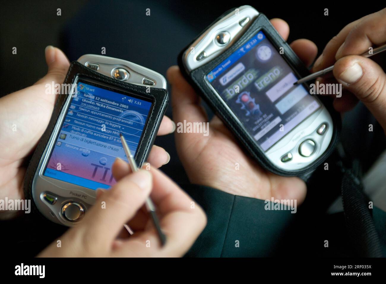 Two hands using styluses on early 2000s Pocket PC devices with stylus ...