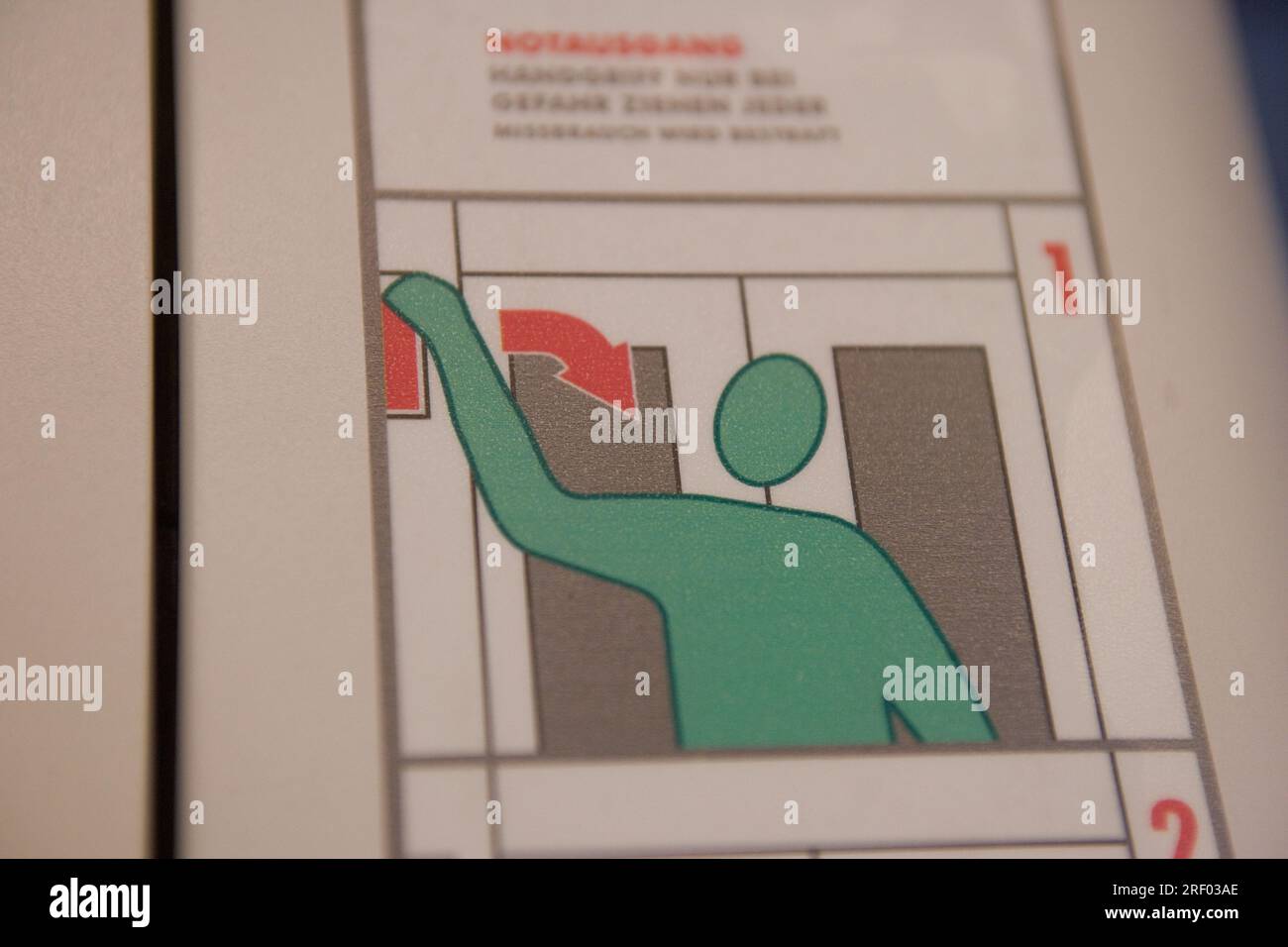 Illustration showing emergency exit instructions with text in German ...