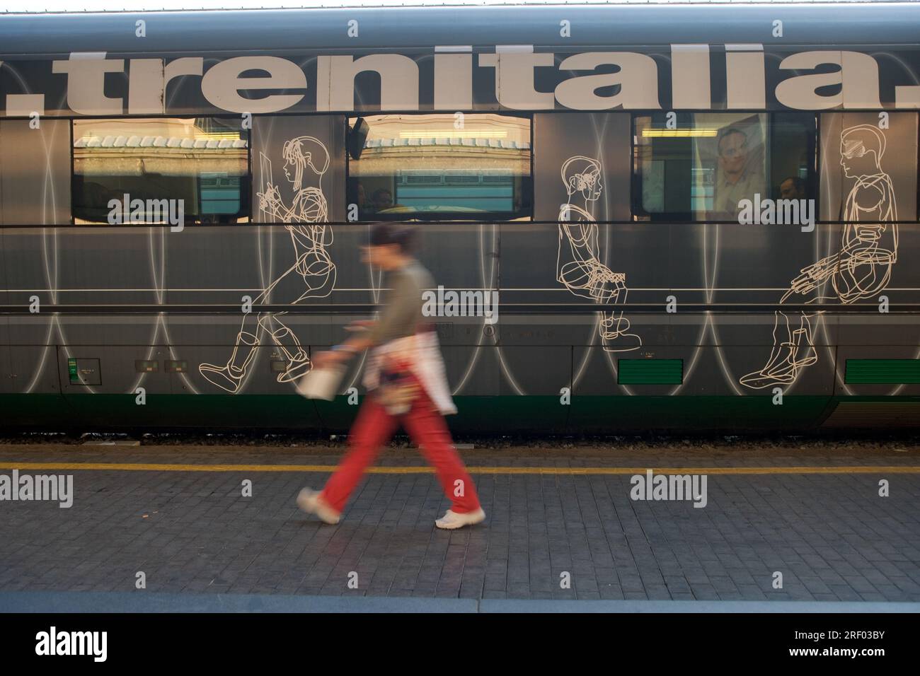 A Trenitalia train with artistic line drawings on its exterior at an ...