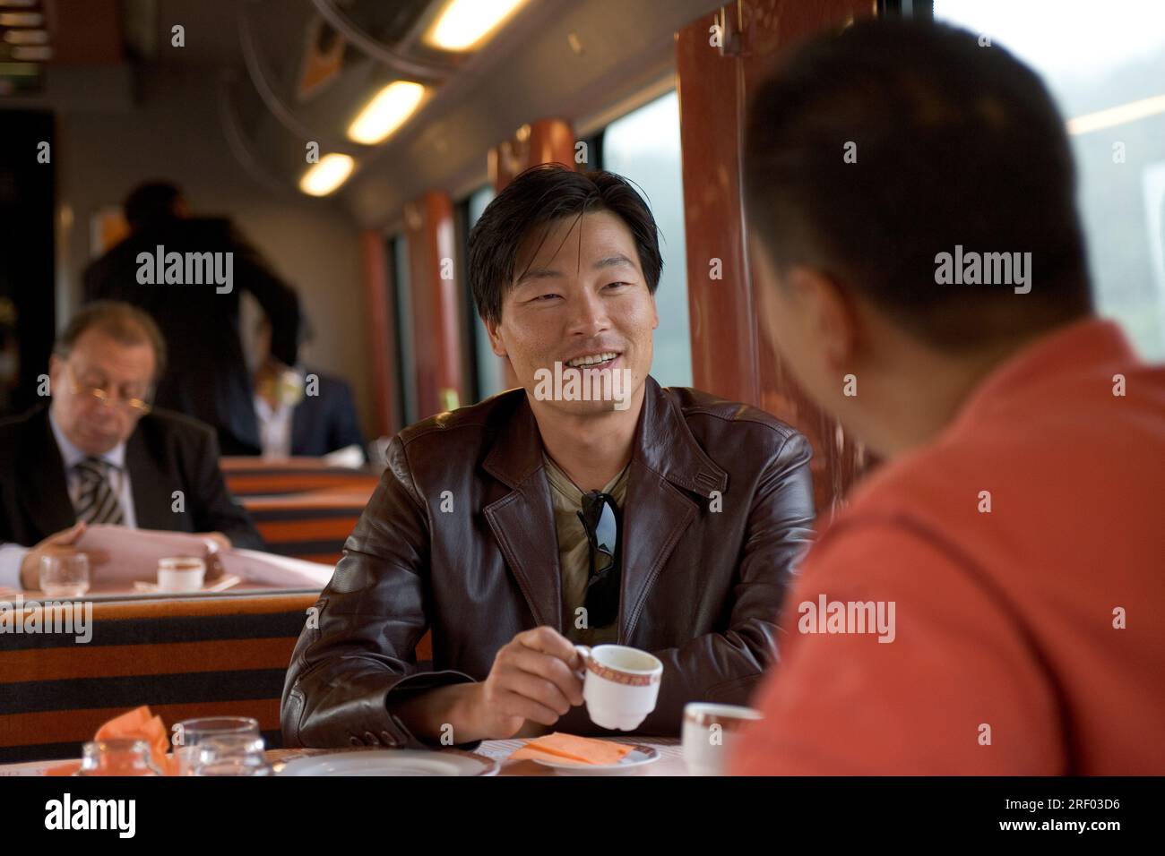 People chatting and drinking coffee inside a train dining car Stock ...