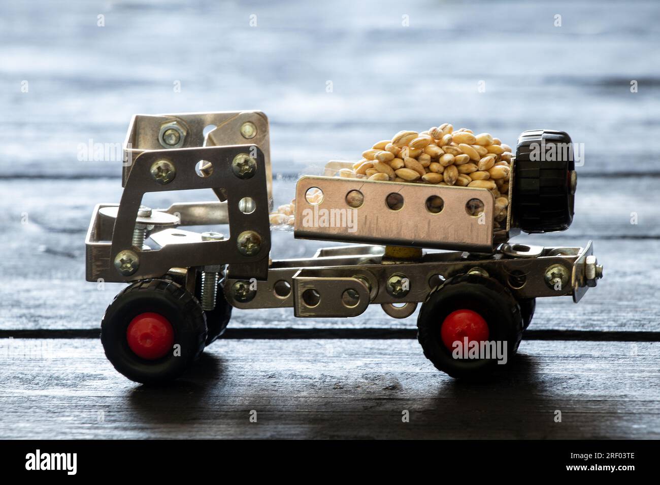 Cargo transportation of grain on a children's typewriter truck made of ...