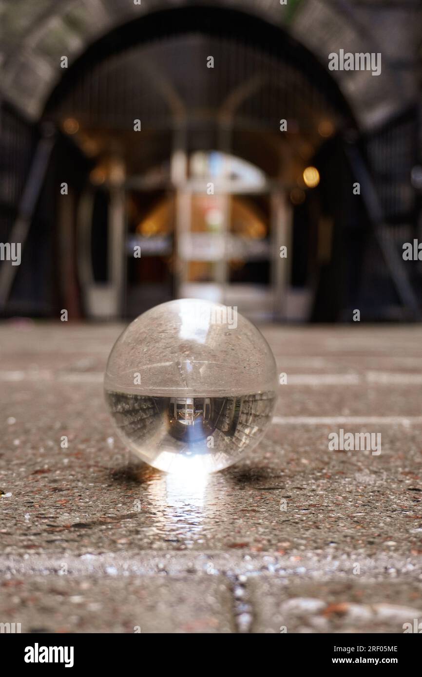 Close up of a crystal ball laying on the ground in the city Stock Photo ...