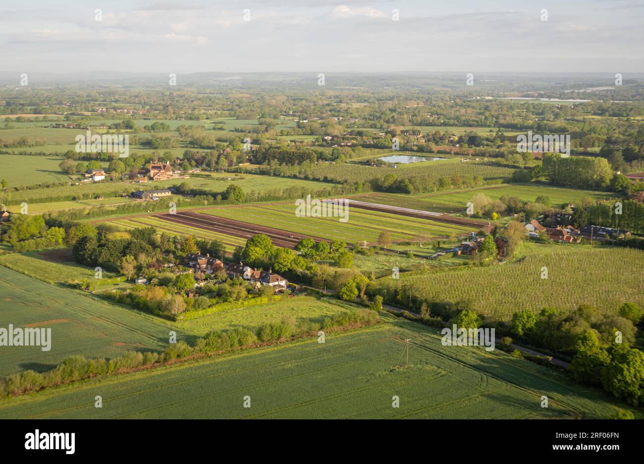 Aerial view of a farm and surrounding fields in the countryside in Kent ...