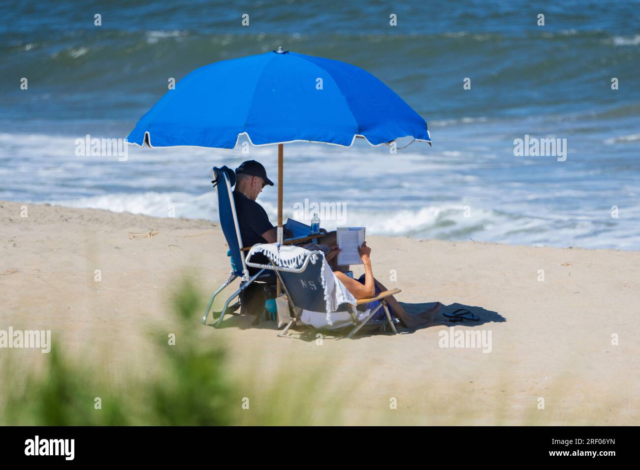 President Joe Biden and first lady Jill Biden sit on the beach ...