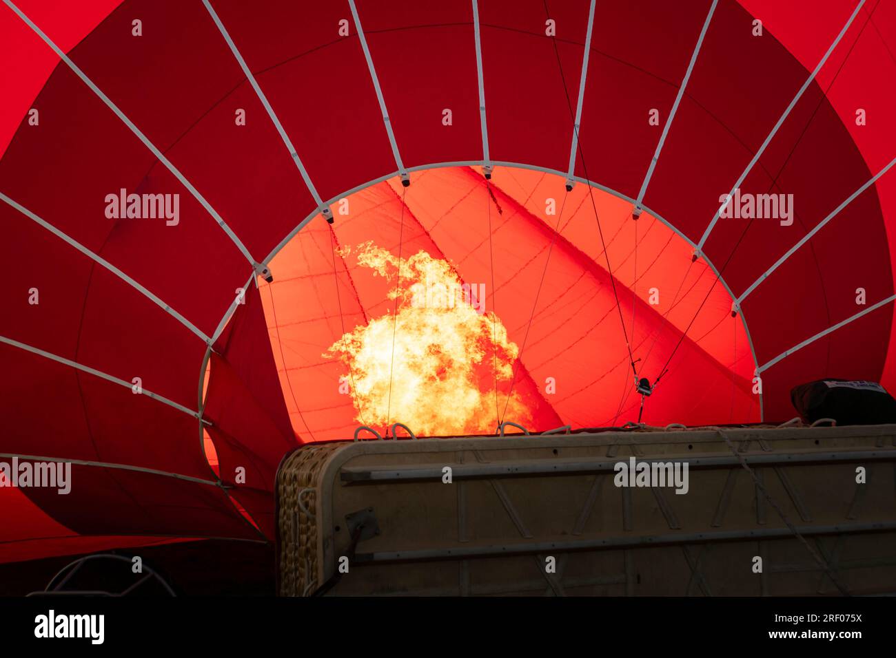 A jet of burning gas inflating a red hot air balloon Stock Photo - Alamy