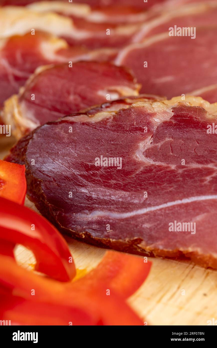 dried red pork meat on the kitchen table, fresh smoked pork ham meat ...
