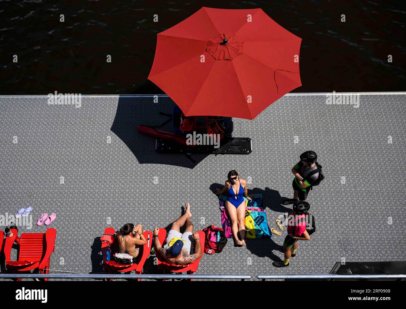 Ottawa, Can. 30th July, 2023. People sunbathe on a dock along the ...