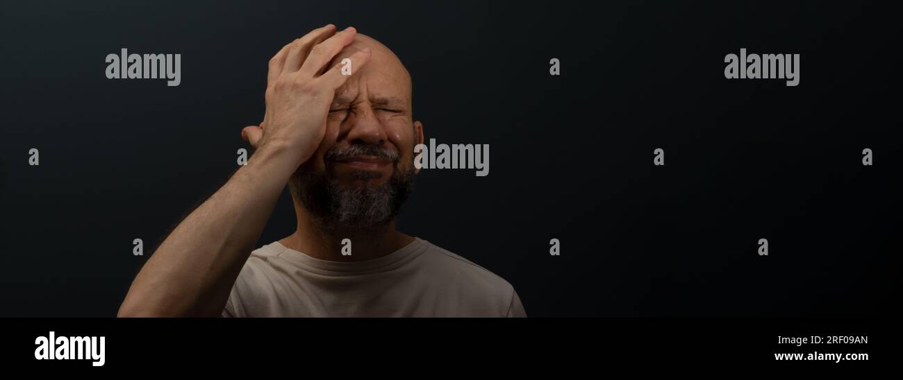 Sad man suffering from headache or migraine. Stressed guy with painful ...