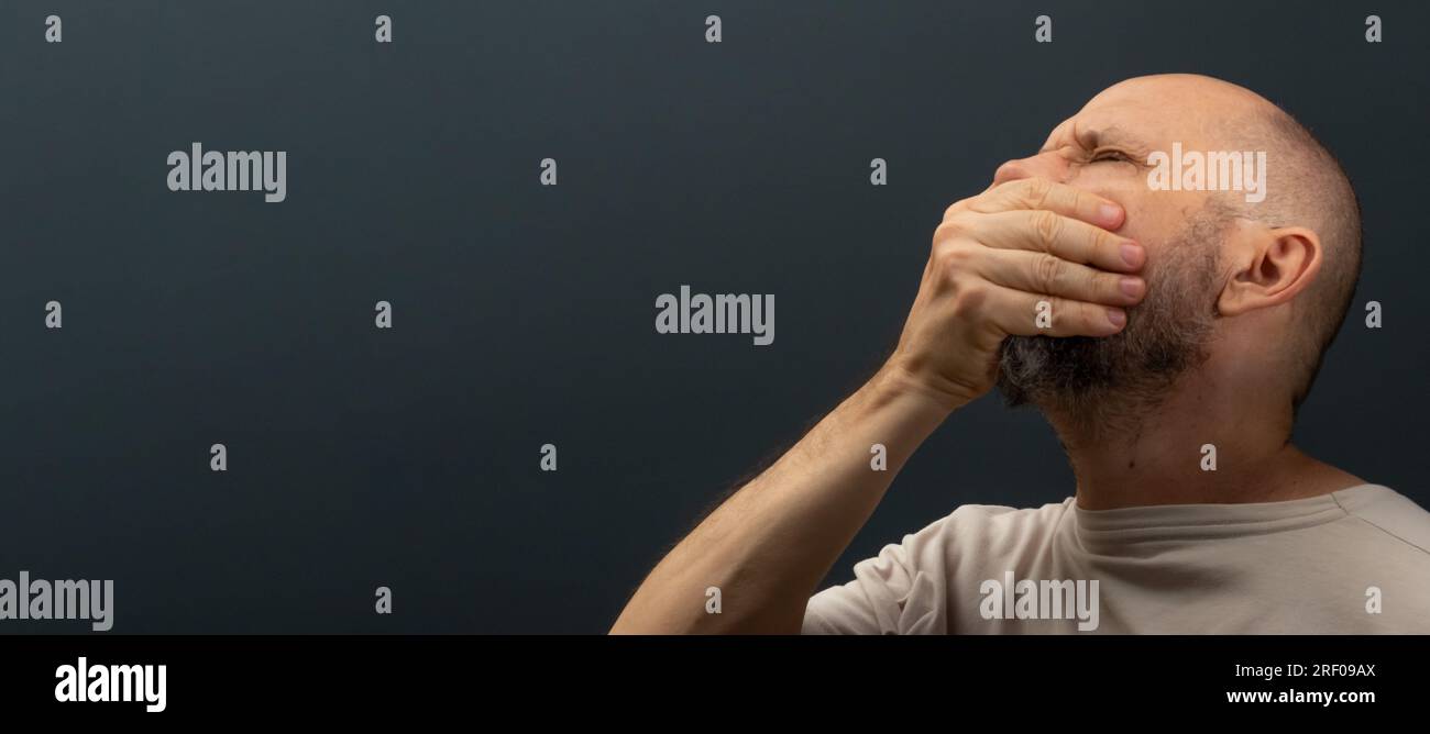 Sad man suffering from headache or migraine. Stressed guy with painful ...