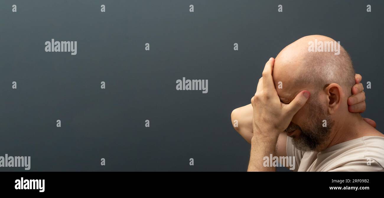 Sad man suffering from headache or migraine. Stressed guy with painful ...