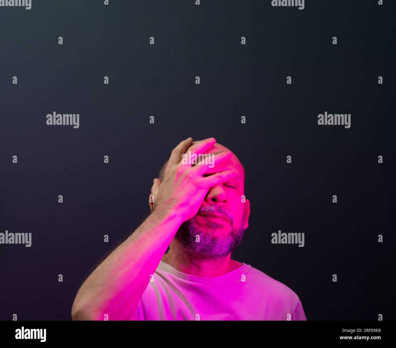 Sad man suffering from headache or migraine. Stressed guy with painful ...