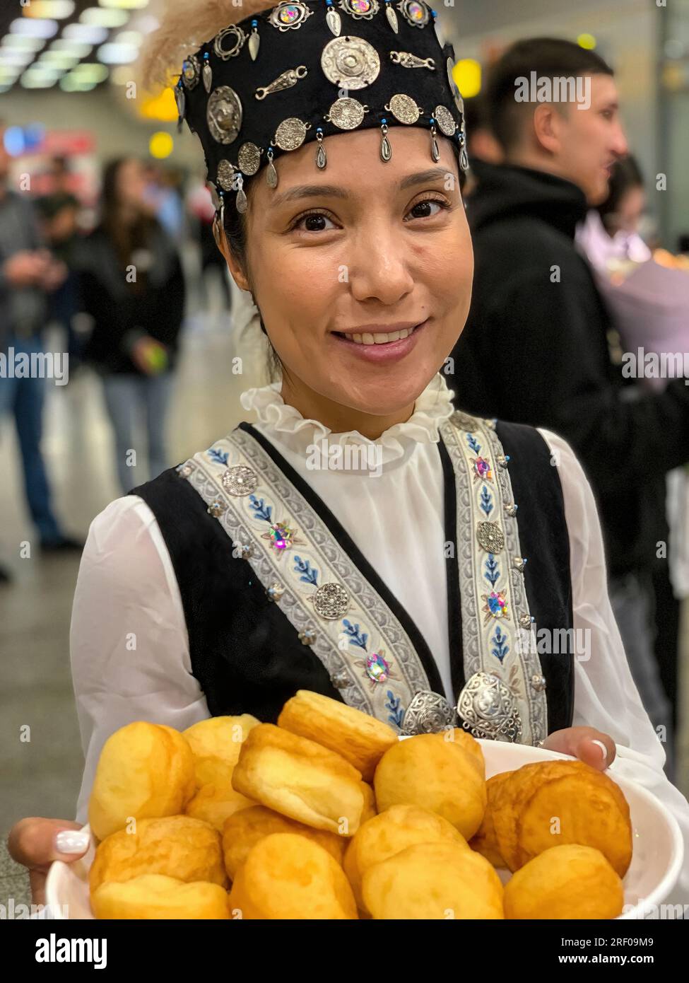 Kazakhstan, Almaty. Young Kazakh Woman Welcoming New Arrivals with ...