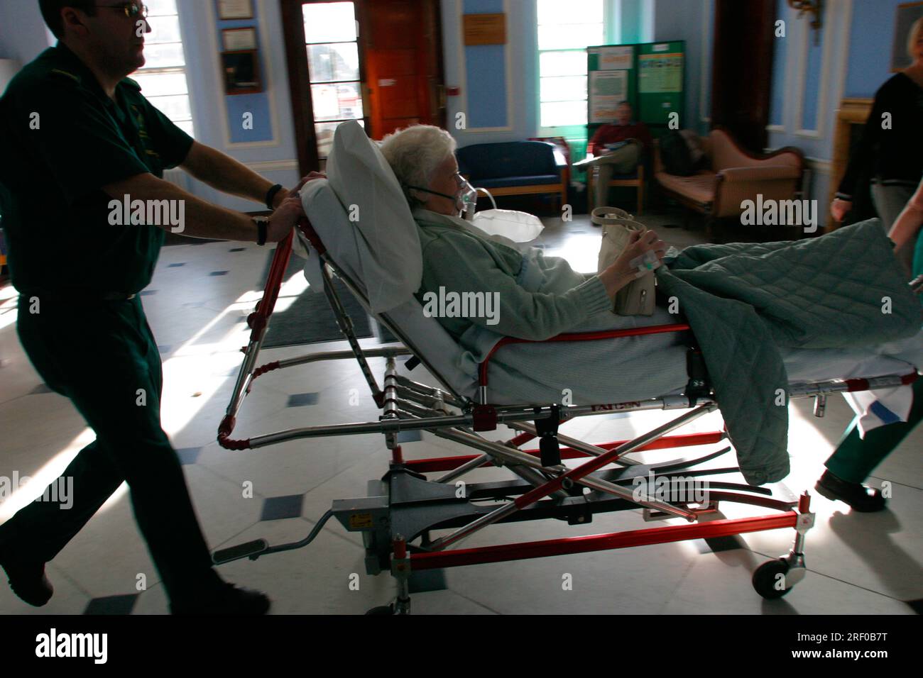 A patient being transported on a stretcher by medical staff in a ...