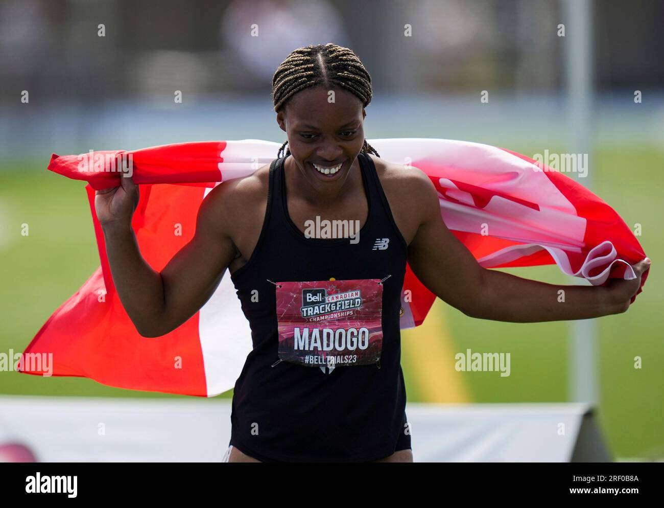 Jacqueline Madogo holds a Canadian flag after winning the women's 200 ...