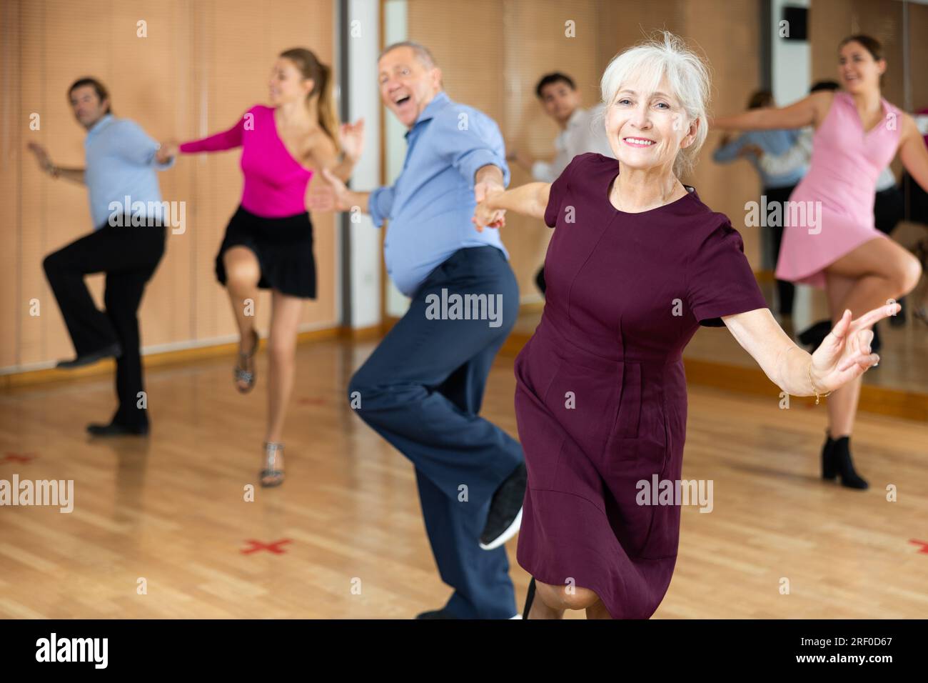 Older woman enjoying active dancing in dance studio Stock Photo - Alamy