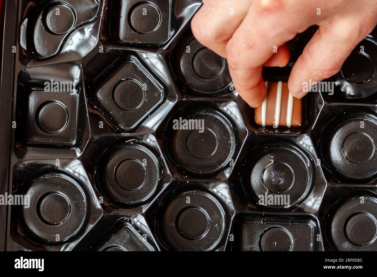 Hand taking the last chocolate hi-res stock photography and images - Alamy