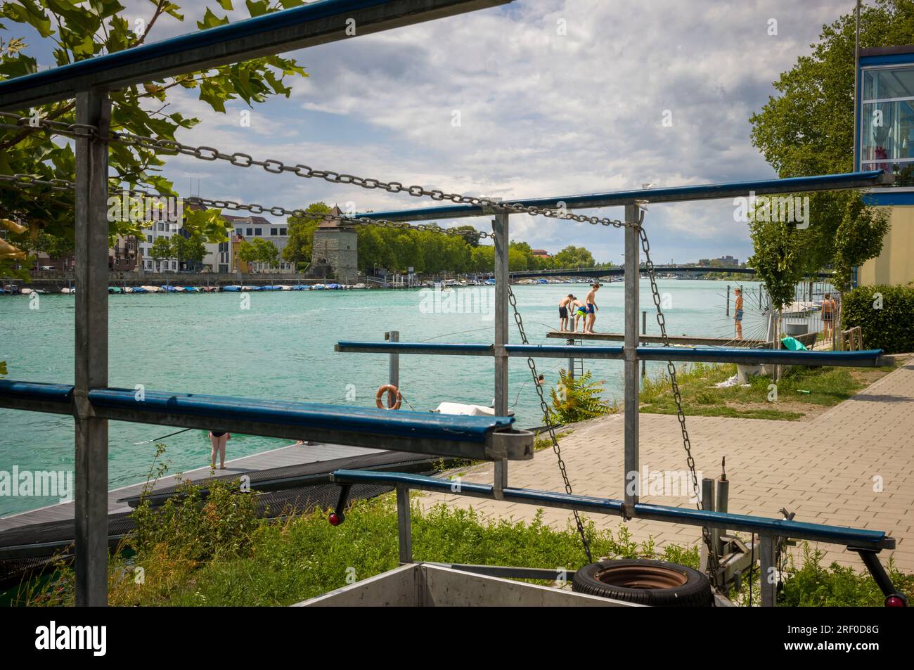 Children sunbathing and jumping into lake Konstanz on hot summer day ...