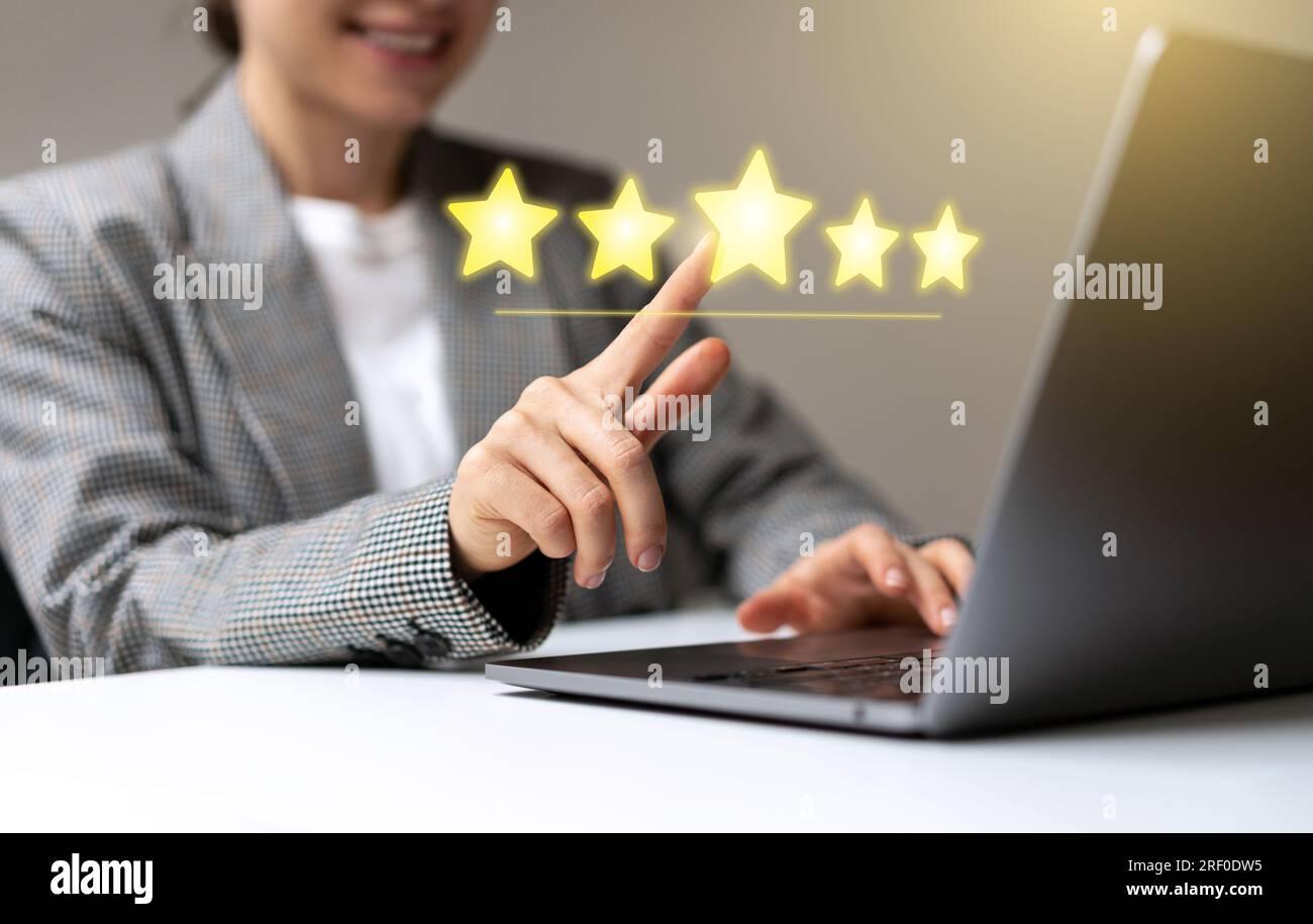 Female person using laptop for sharing her consumer experience feedback ...