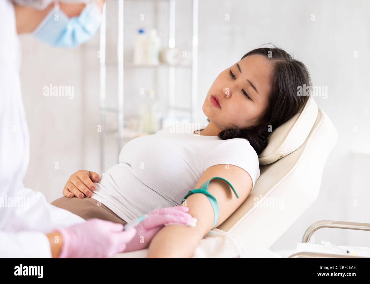 Middle-aged doctor giving injection into vein Stock Photo - Alamy
