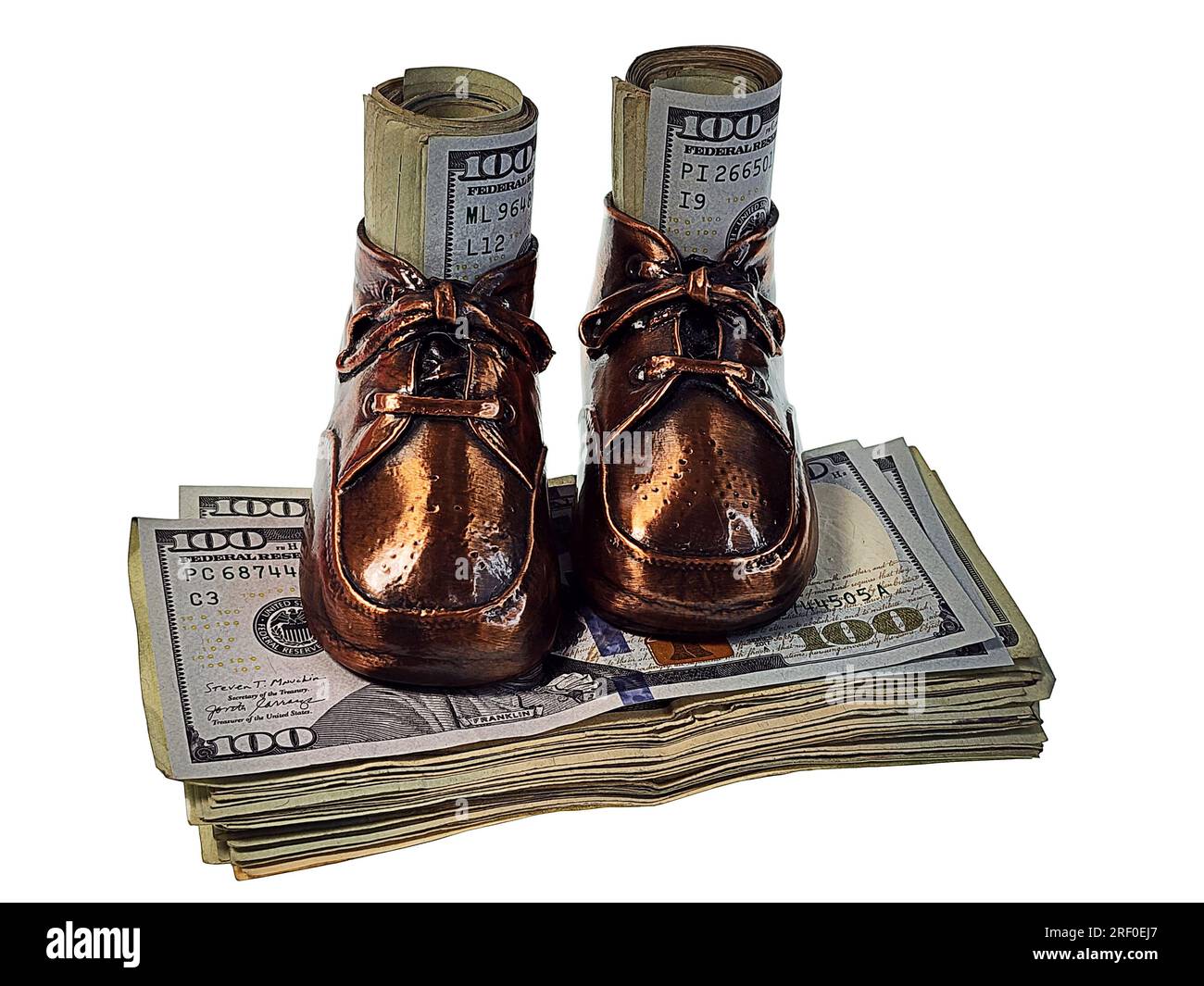 Bronzed baby shoes with a stack of money to show saving for the future ...