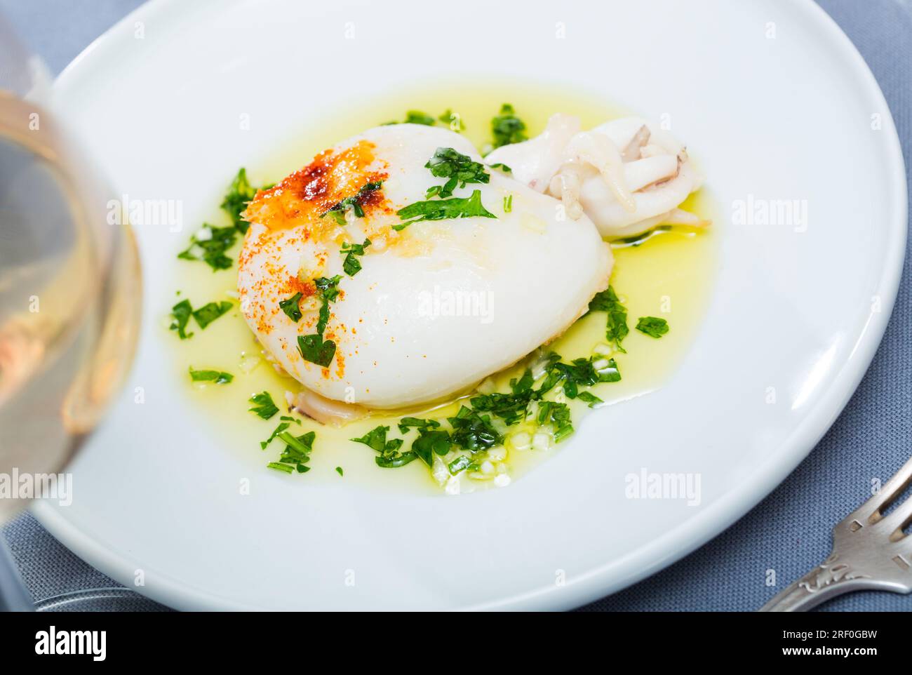 Roasted sepia with green sauce Stock Photo - Alamy
