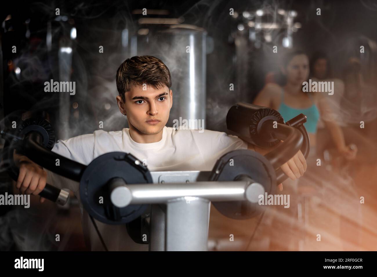 Guy pumping up deltoid muscles in lateral raise exercise machine Stock ...