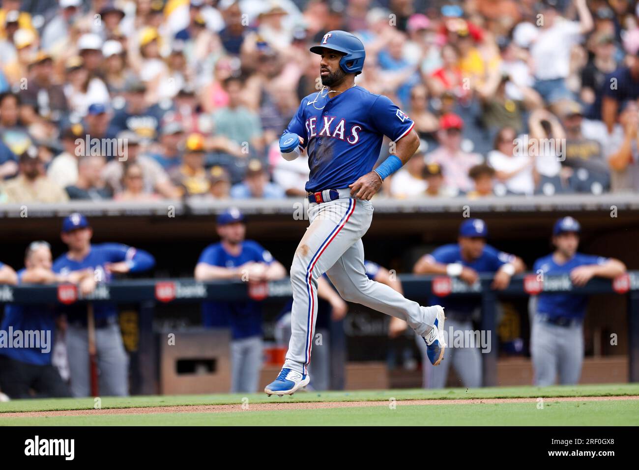 Texas Rangers' Ezequiel Duran heads home to score on a throwing error ...