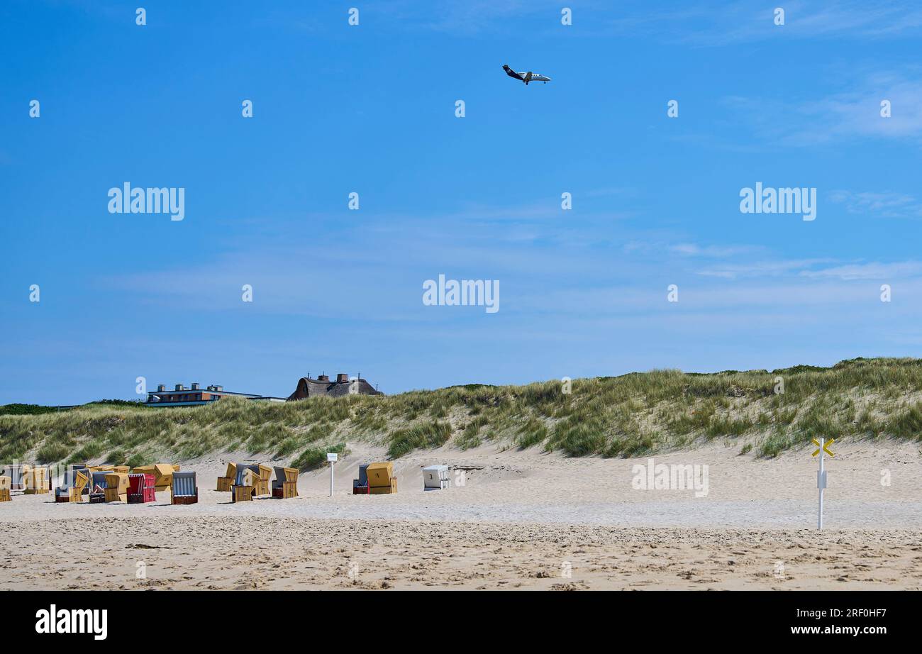 Tourists at the beach with private jet on June 24, 2023 in Westerland ...