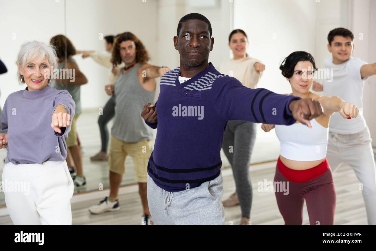 Group of multinational people practicing new modern dance techniques ...
