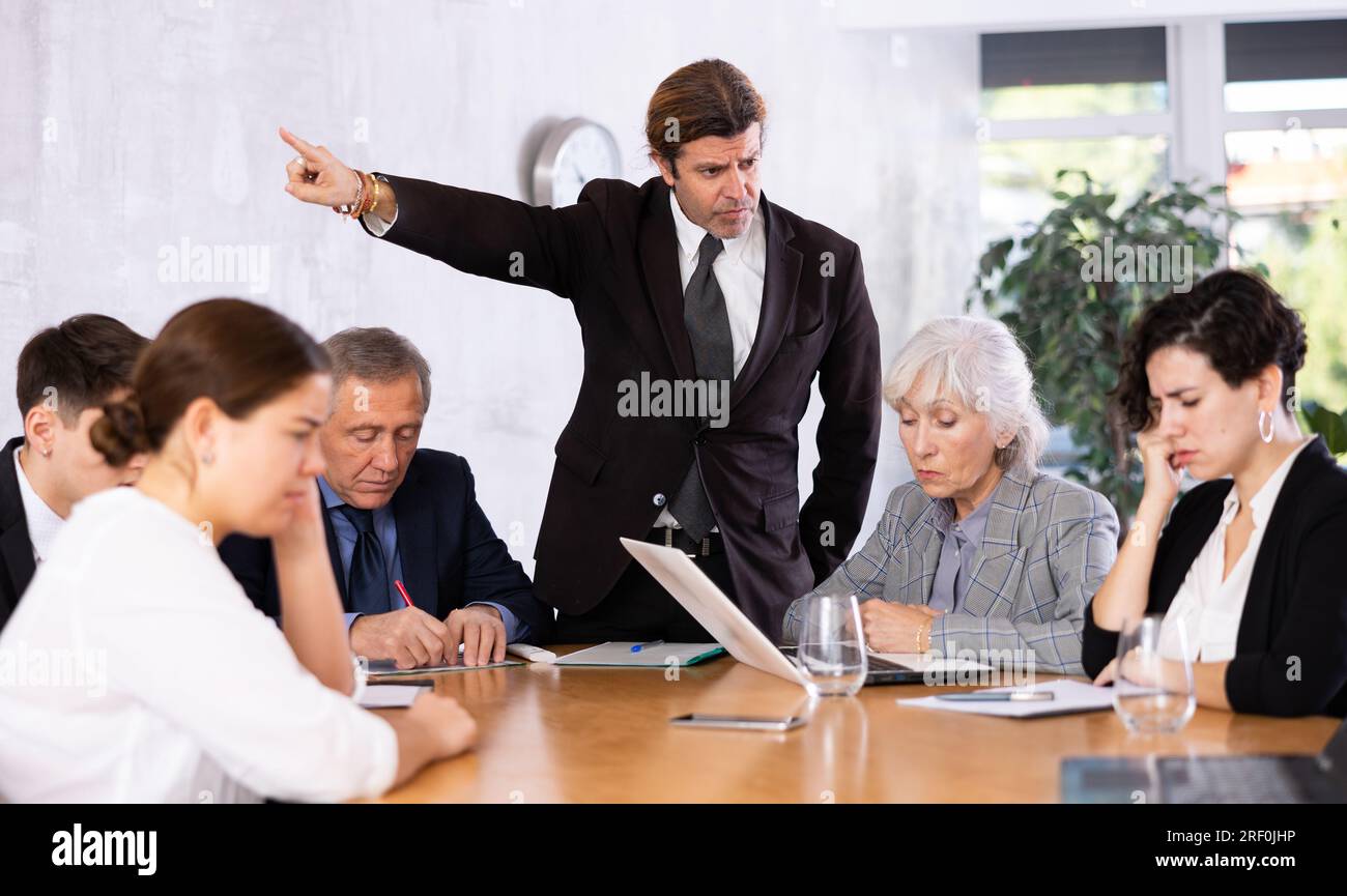 Furious male boss yelling at office colleagues of different ages taking ...
