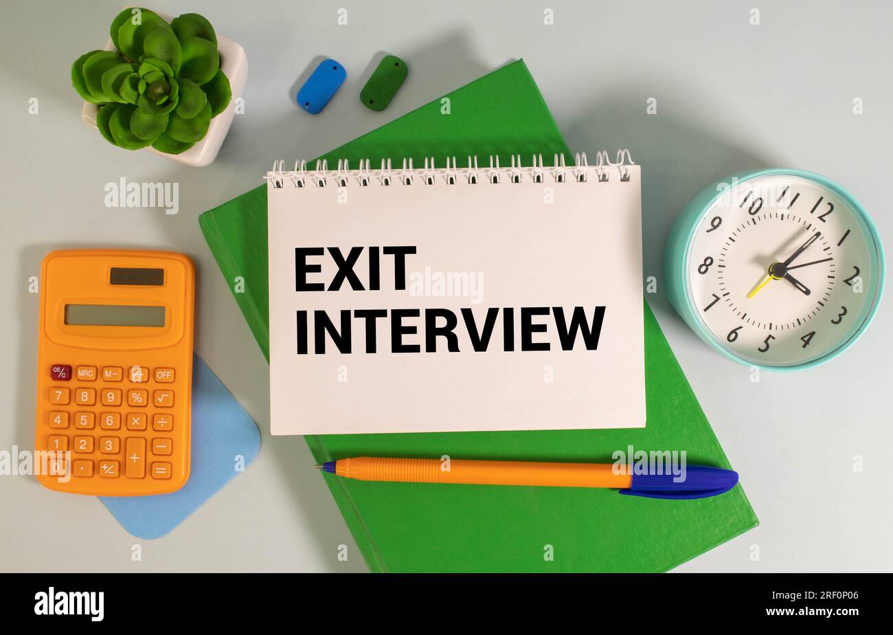 Business concept.Text EXIT INTERVIEW writing on notepaper with pen and ...