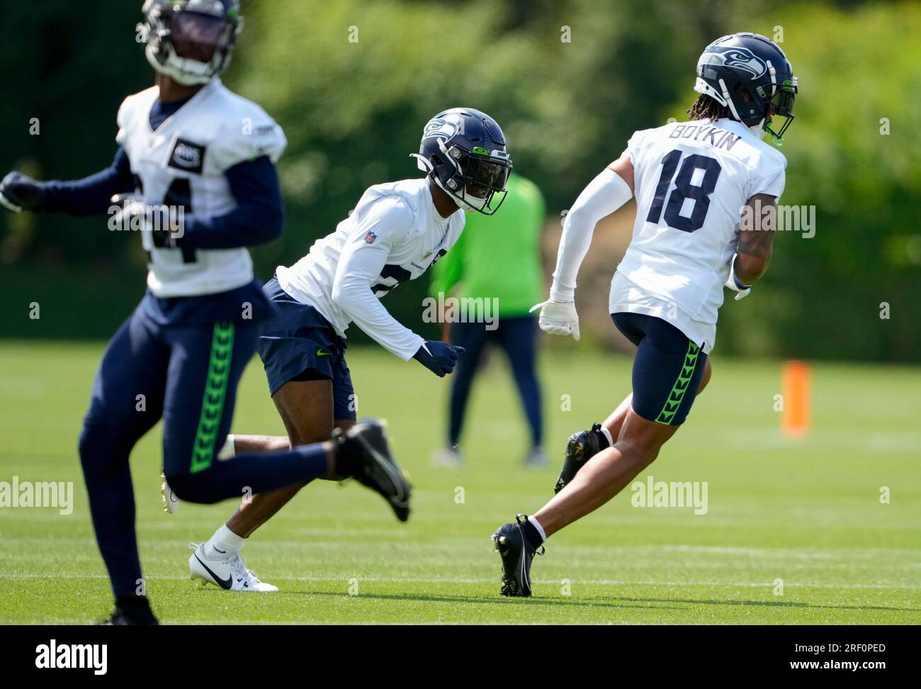 Seattle Seahawks cornerback Devon Witherspoon, center, runs a drill ...