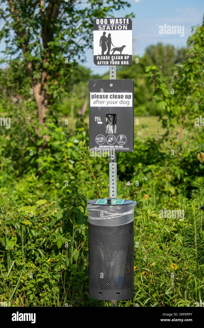 A dog poop station with bags and a trash bin in Osage Park in ...