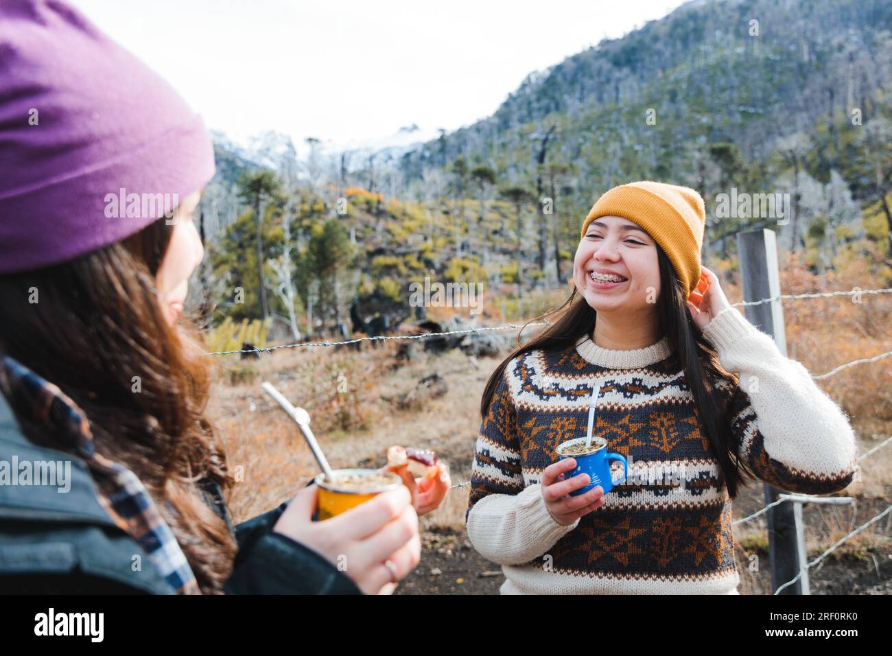 Two young latin women enjoying yerba mate outside in the mountain ...