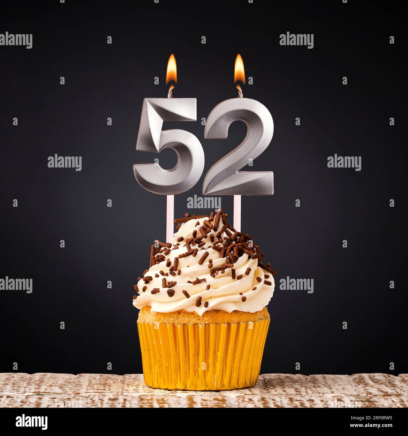 birthday cupcake with number 52 candle - Celebration on dark background ...