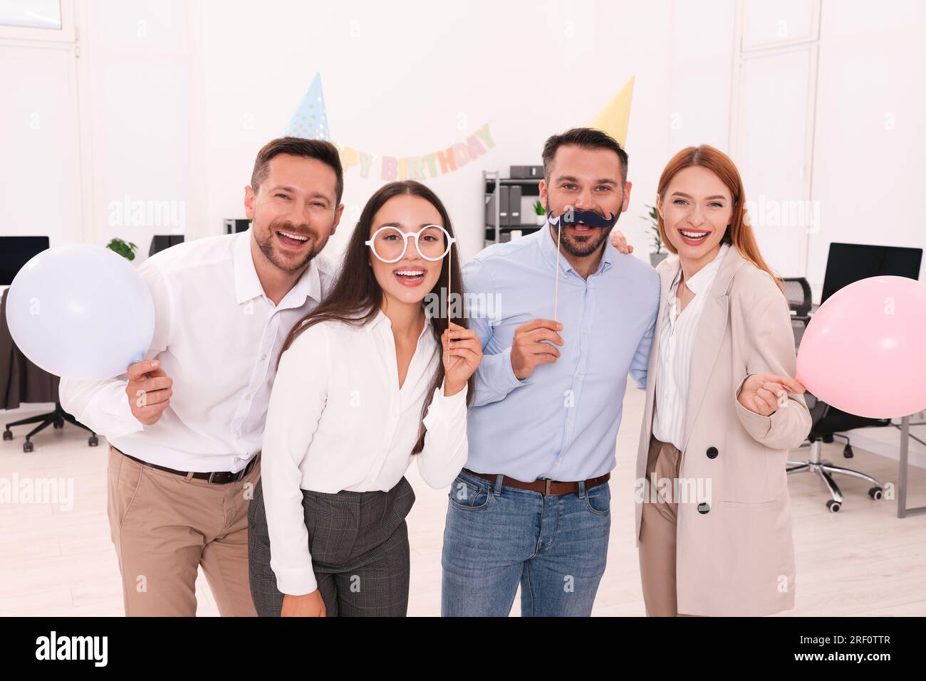 Coworkers having fun during office party indoors Stock Photo - Alamy