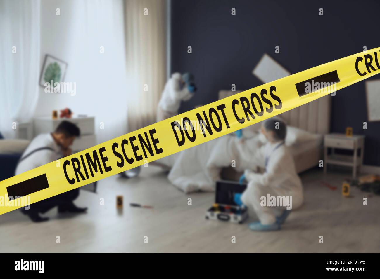 Yellow tape blocking way to crime scene. Investigator and criminologist ...