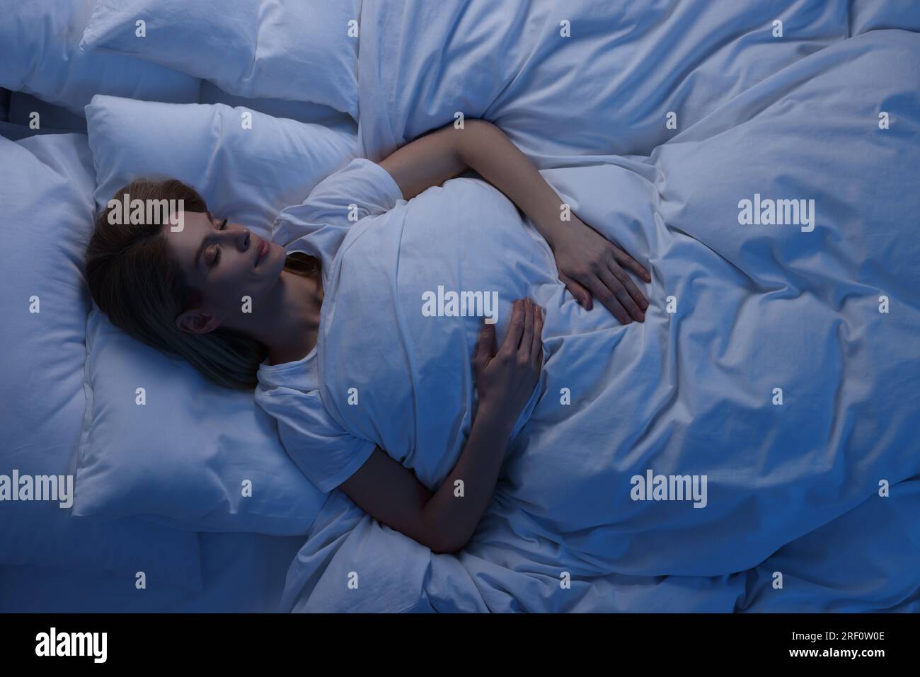 Woman sleeping in bed at night, above view Stock Photo - Alamy