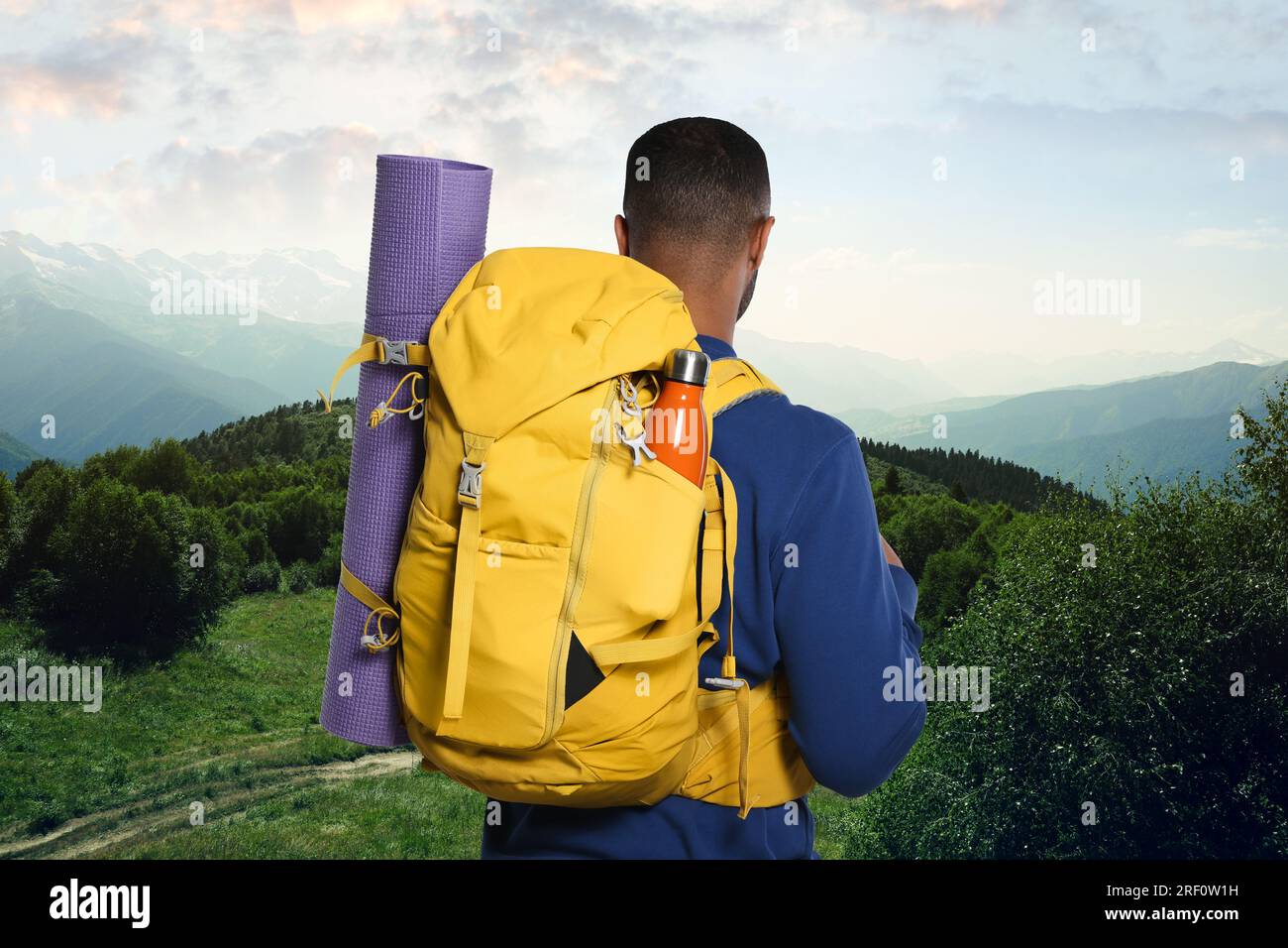 Tourist with backpack in mountains, back view Stock Photo - Alamy