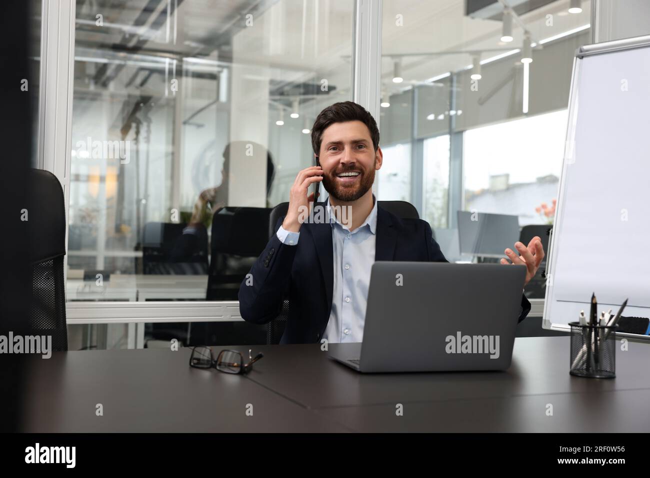 Happy black businessman talking desk hi-res stock photography and ...
