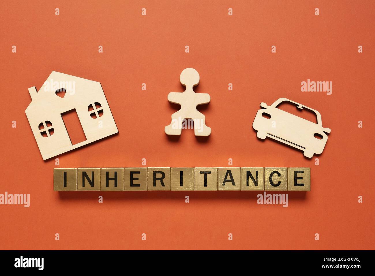 Word Inheritance made with cubes and different cutouts on orange ...
