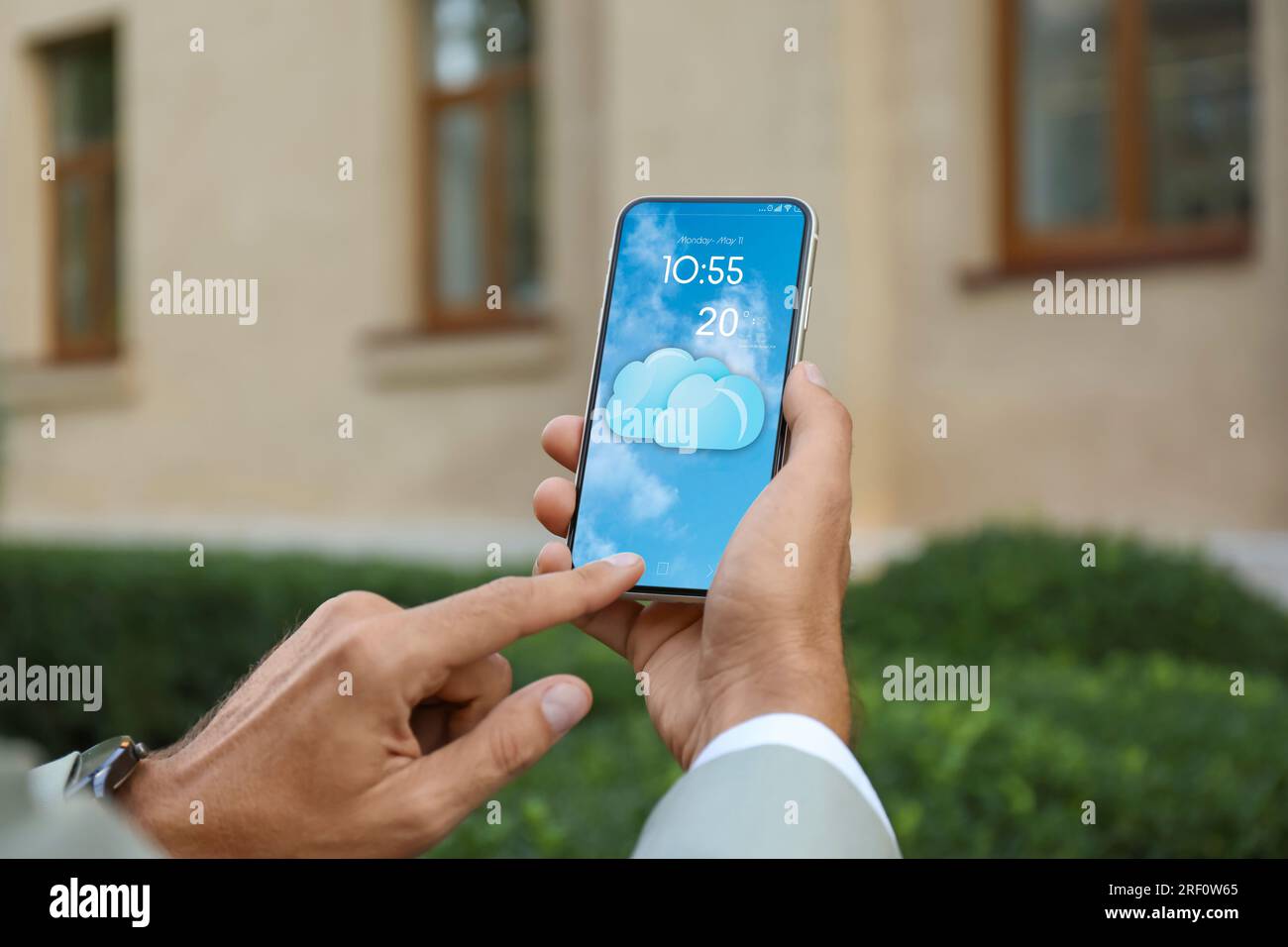 Man checking weather using app on smartphone outdoors, closeup. Data ...