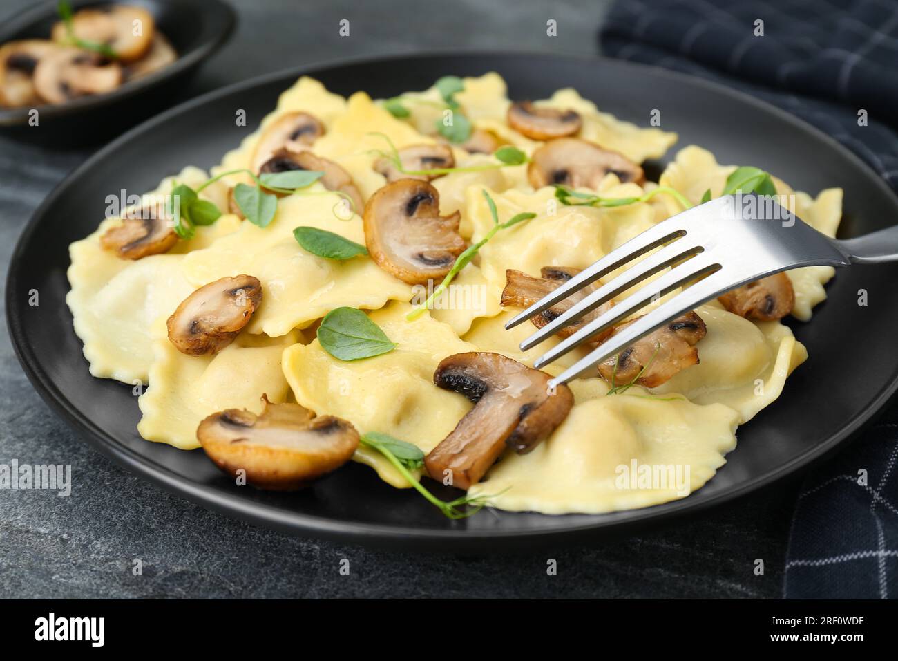 Delicious ravioli with mushrooms served on grey table, closeup Stock ...