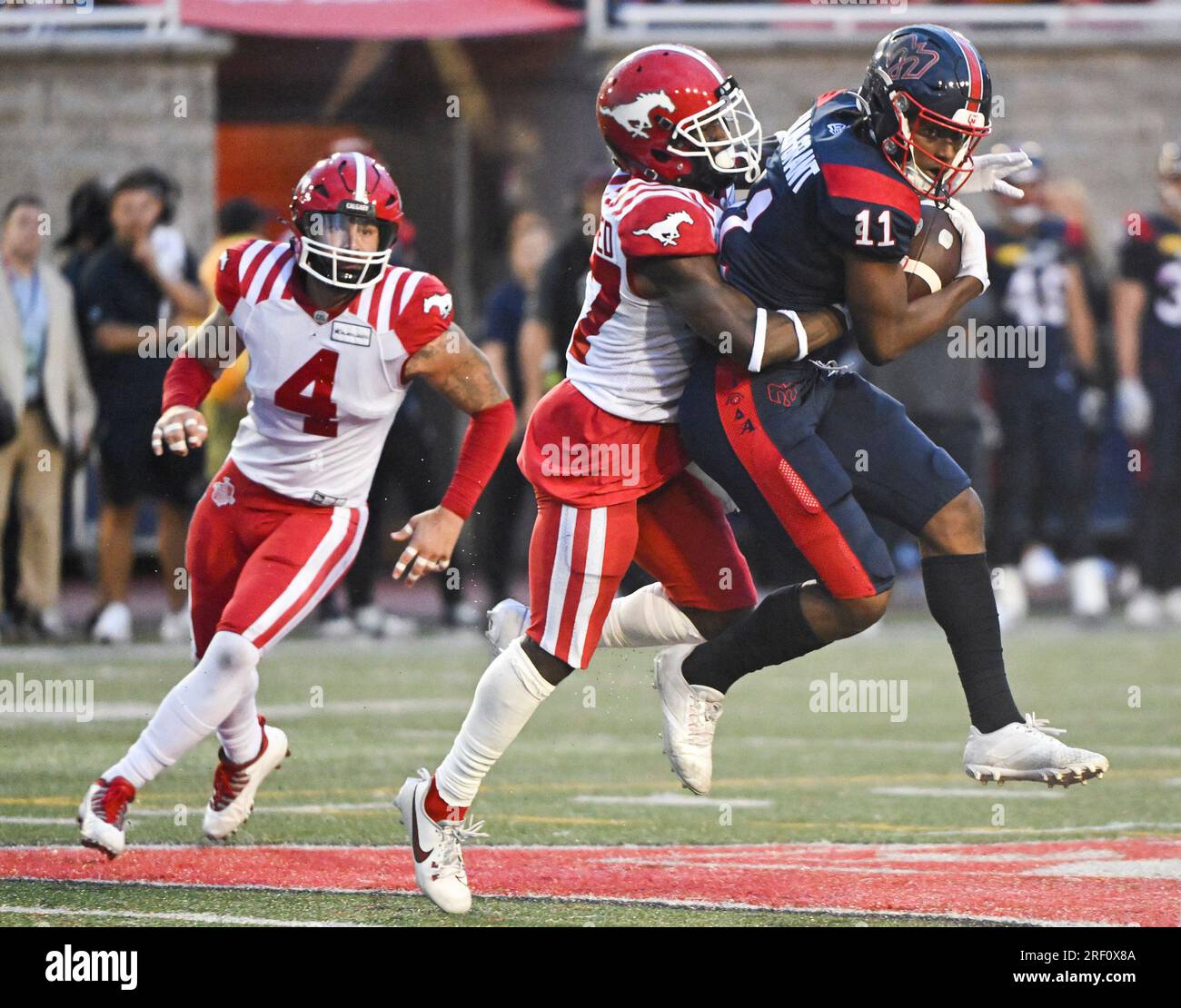 Montreal Alouettes' Kaion Julien-Grant (11) is tackled by Calgary ...
